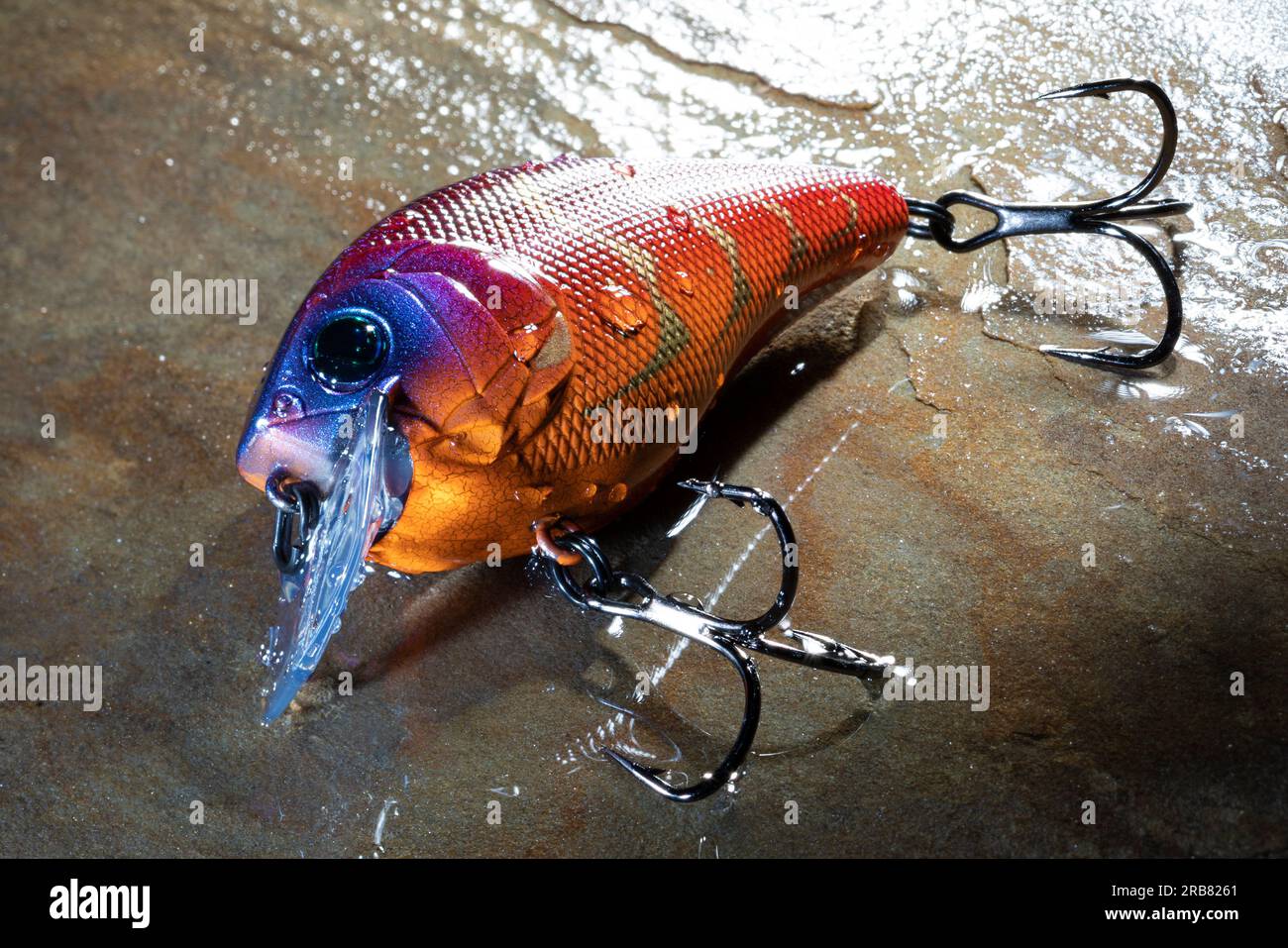 Plastic fishing bait and rock that are soaked wet Stock Photo - Alamy