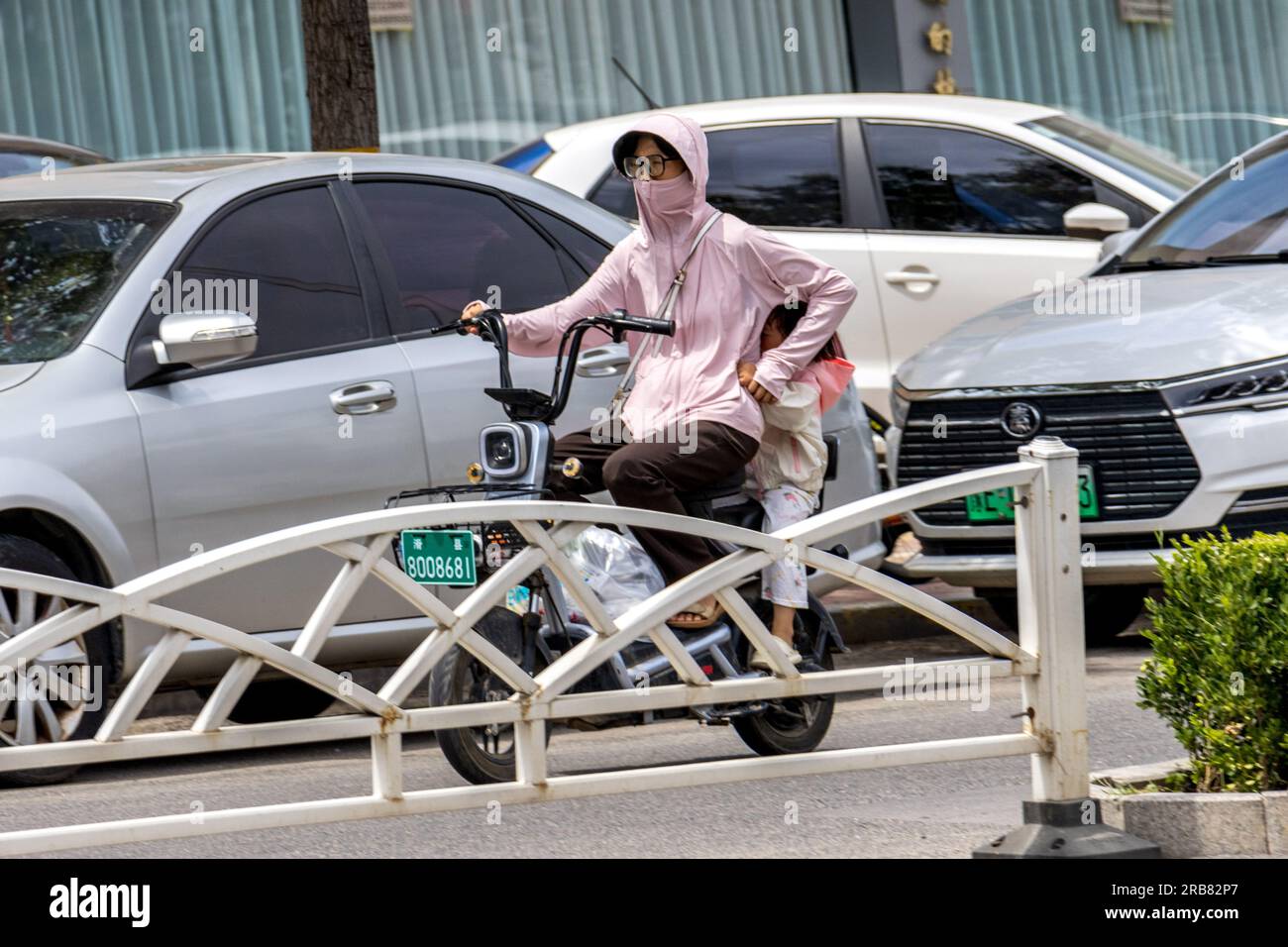 ANYANG, CHINA - JULY 8, 2023 - A pedestrian wearing protective clothing ...