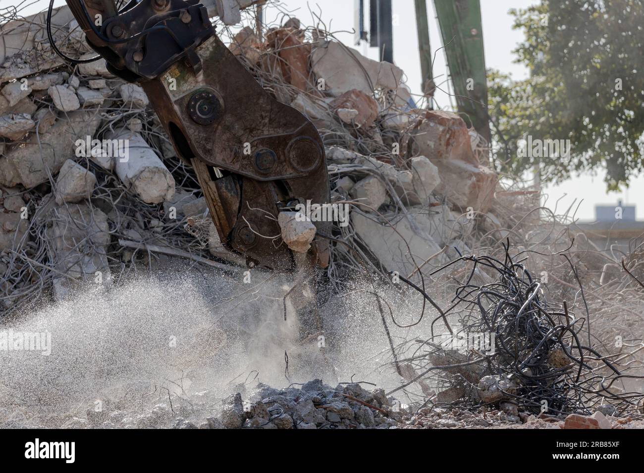 Crusher machine demolishing concrete on a demolition project Stock ...