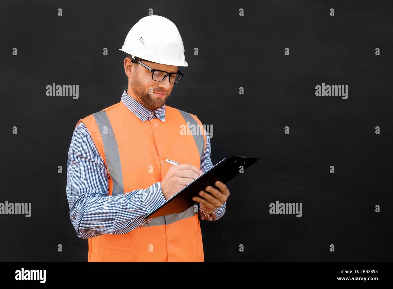 Male Engineer in a White Hard Hats and Orange West. Handsome Confident ...