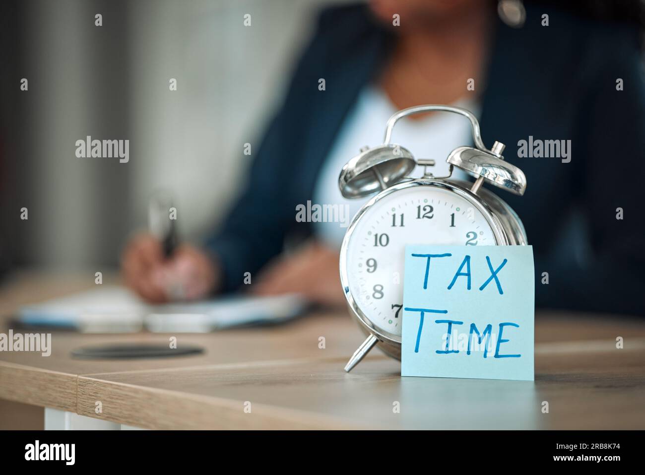 Taxes, time and business person writing for financial report ...