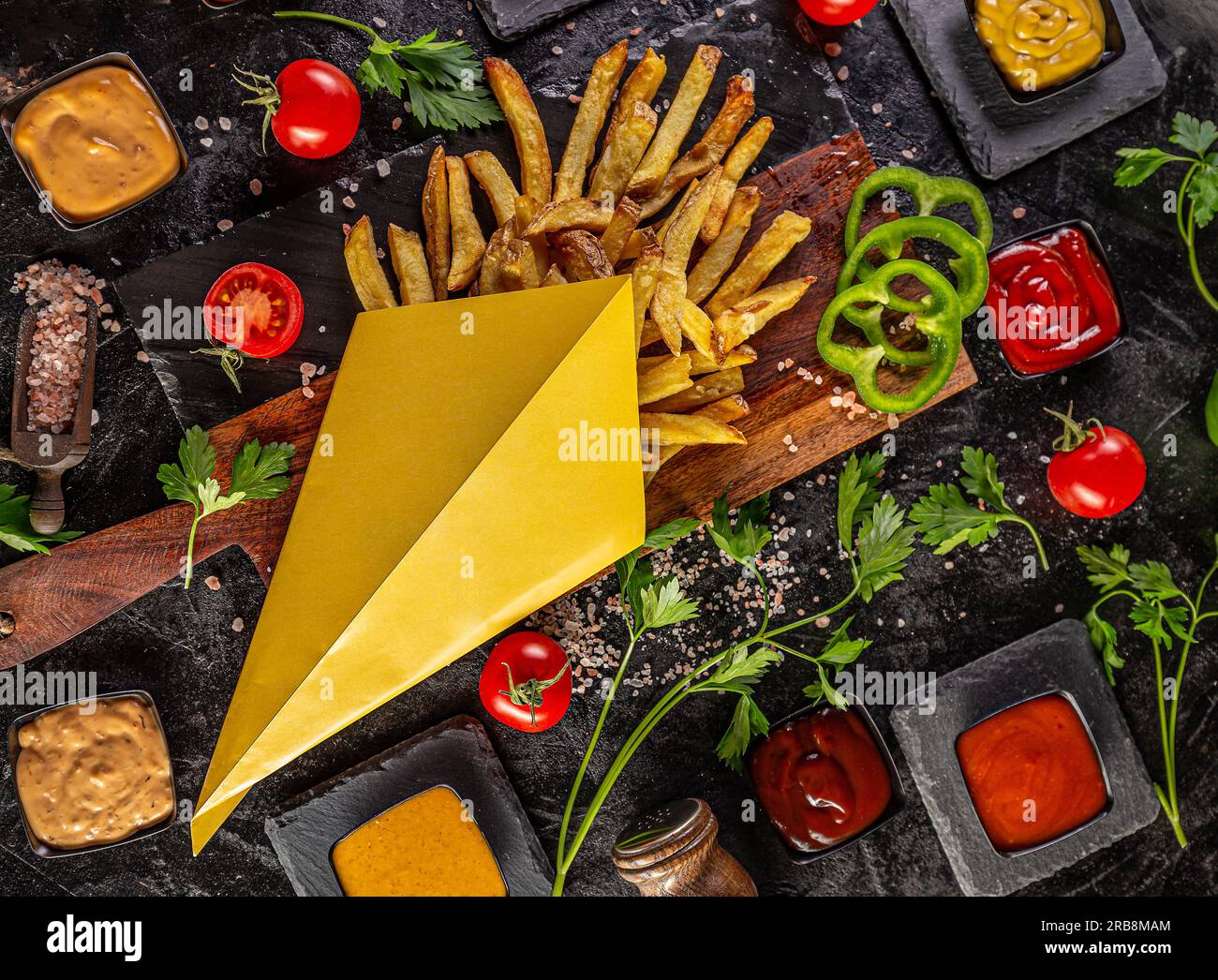 Potatoes fries in a little yellow paper bag, top view, still life Stock ...