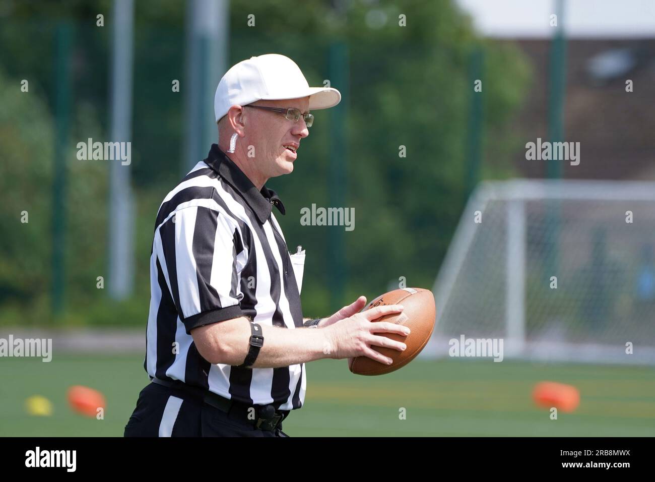 American football official with ball Stock Photo - Alamy