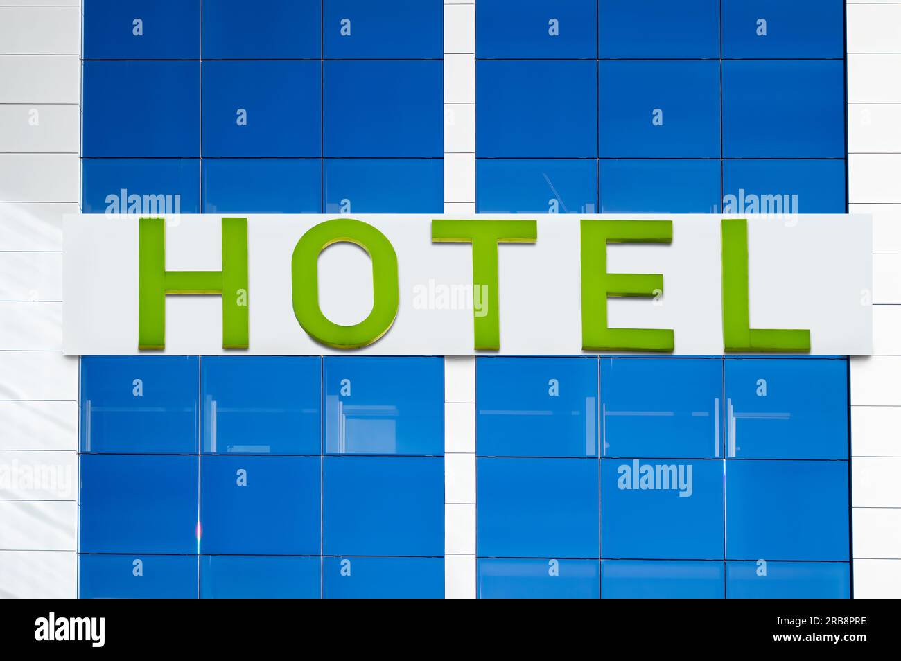 Frontal hotel word with green letters on luxury hotel Stock Photo - Alamy