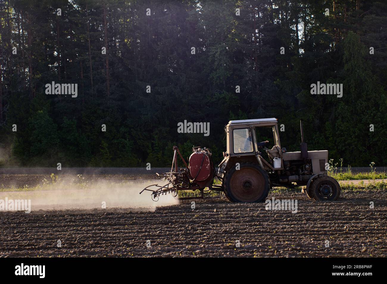 Applying herbicides to crops using sprayer on boom mounted on an ...