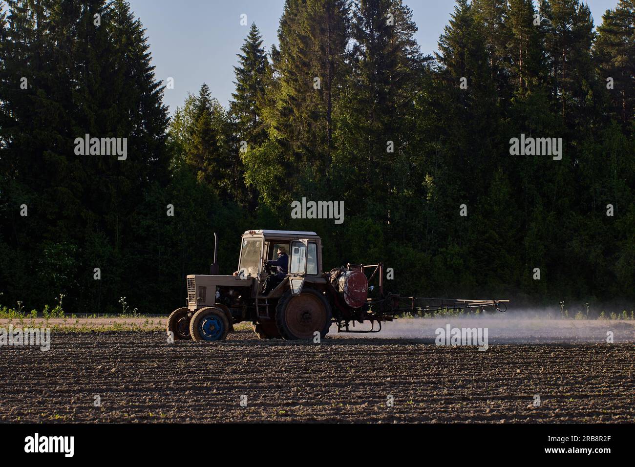 Farmer using tractor spray field hi-res stock photography and images ...