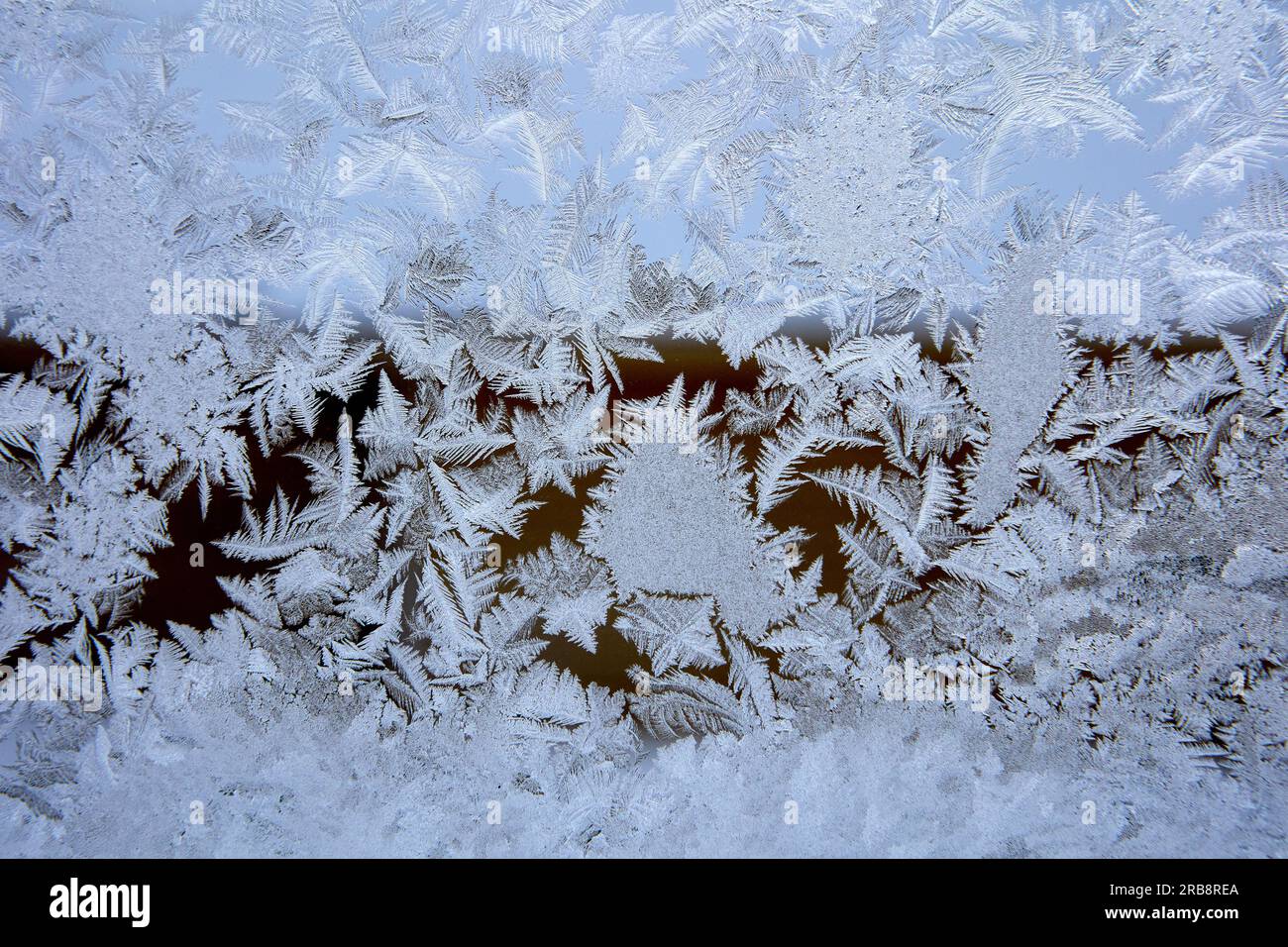 Frost patterns on frozen glass of winter window Stock Photo - Alamy