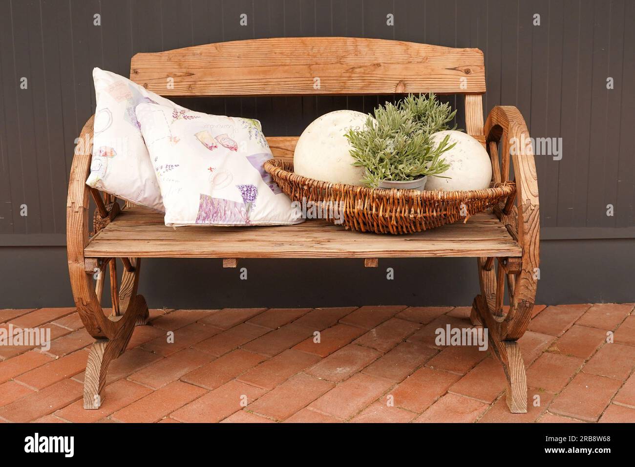 Stylish wooden bench with pillows and floral decor, garden decor and ...