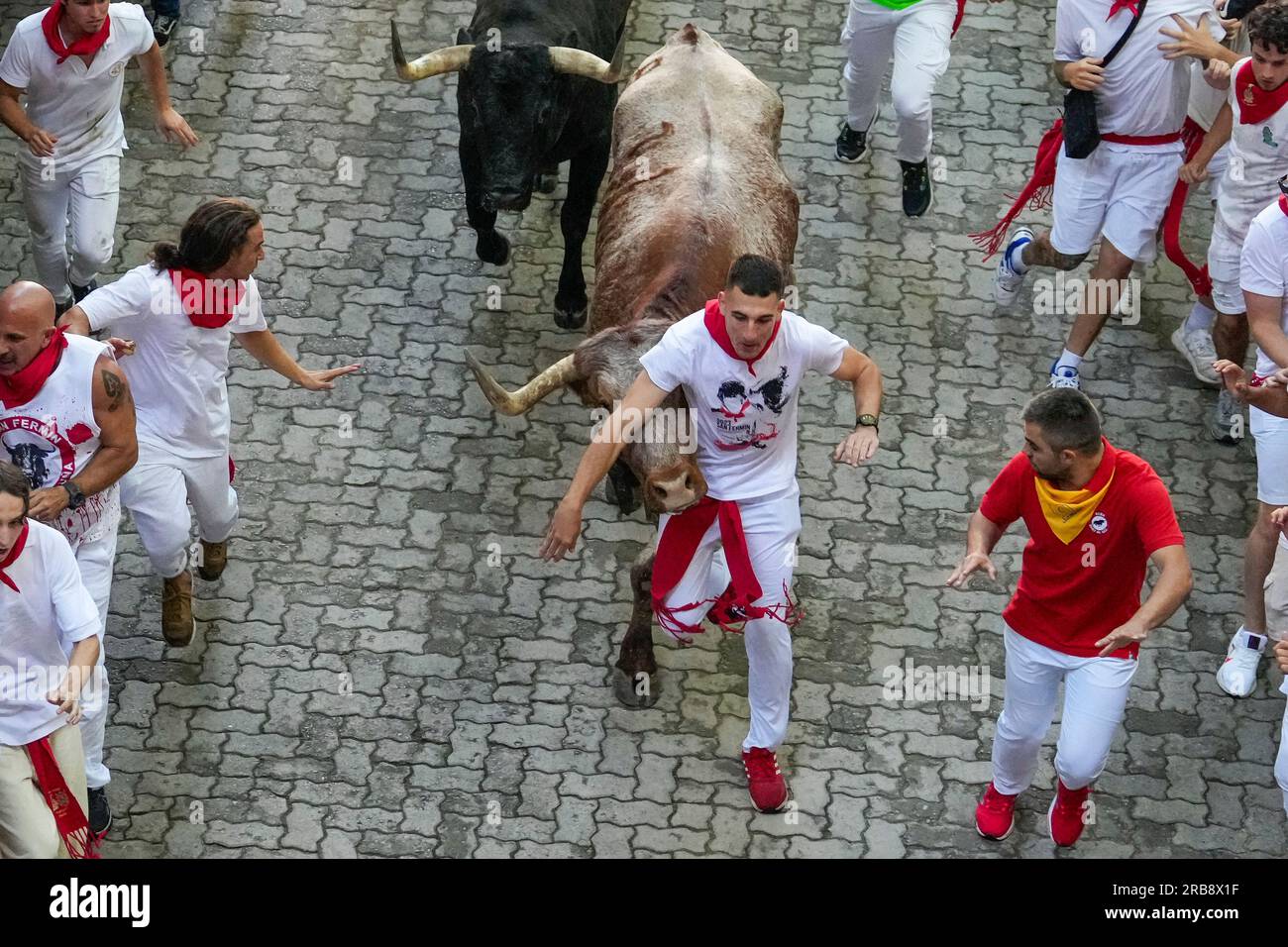 Pamplona, Spain. 08th July, 2023. A bull bumps a runner near the ...