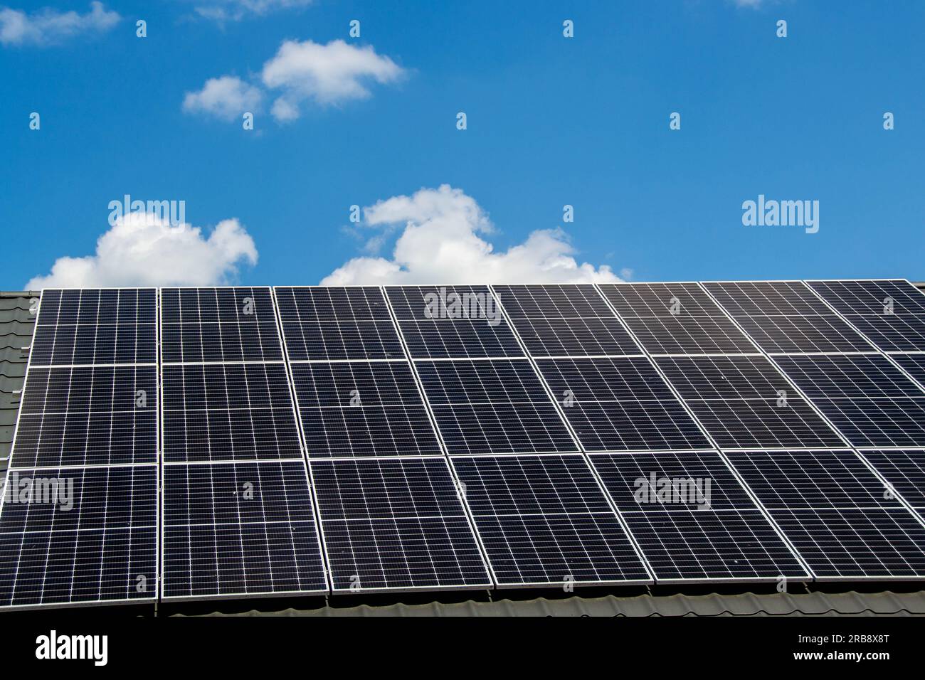 House roof with photovoltaic modules. Historic farm house with modern ...