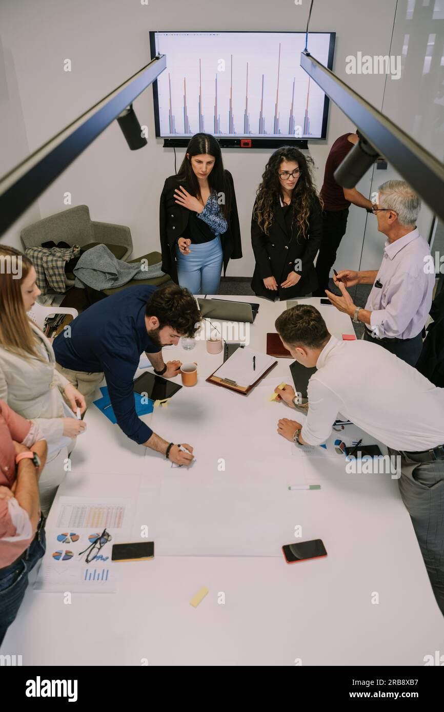 Multiracial group of people cooperating in a modern office. They ...