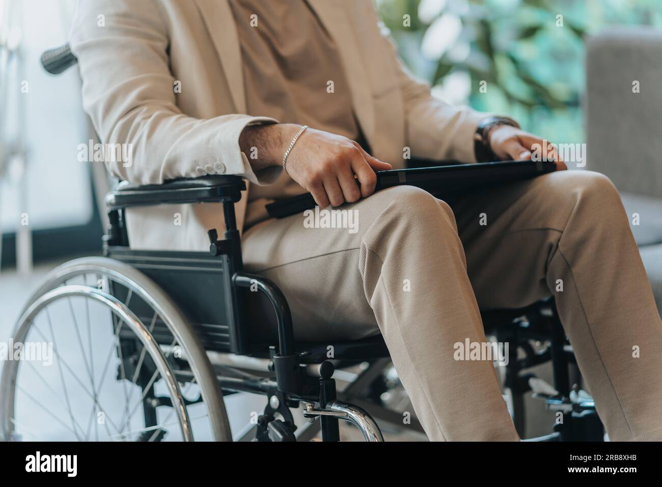 Disabled man on wheelchair in office wearing presentable suit ...