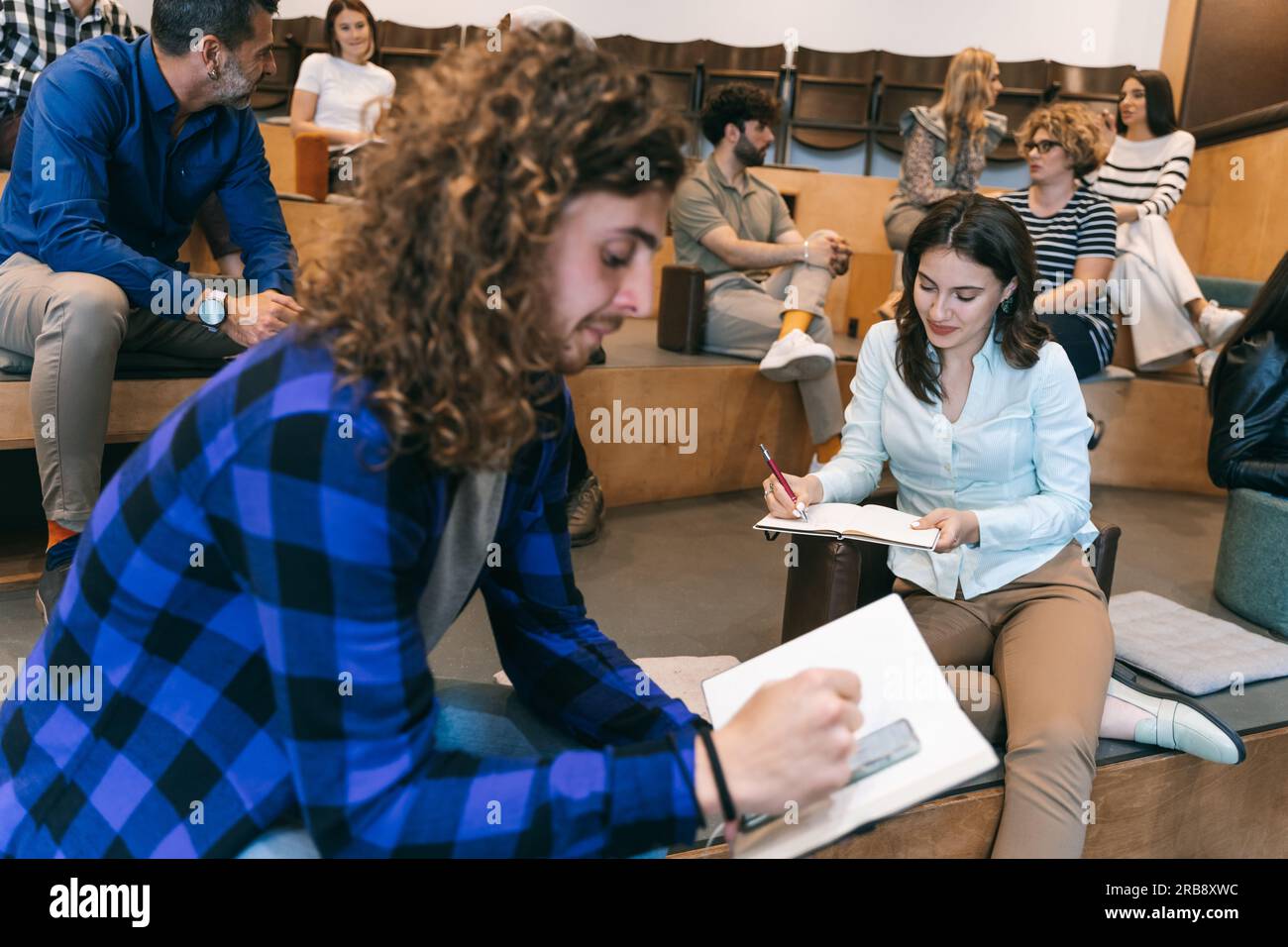 Inter-generational group of businesspeople working together at small ...