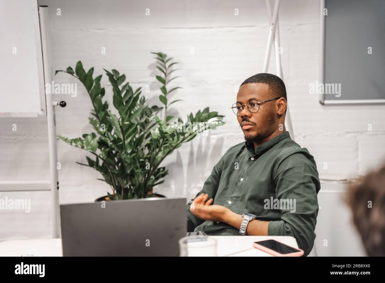 Good looking male employee staring at something while deeply over ...