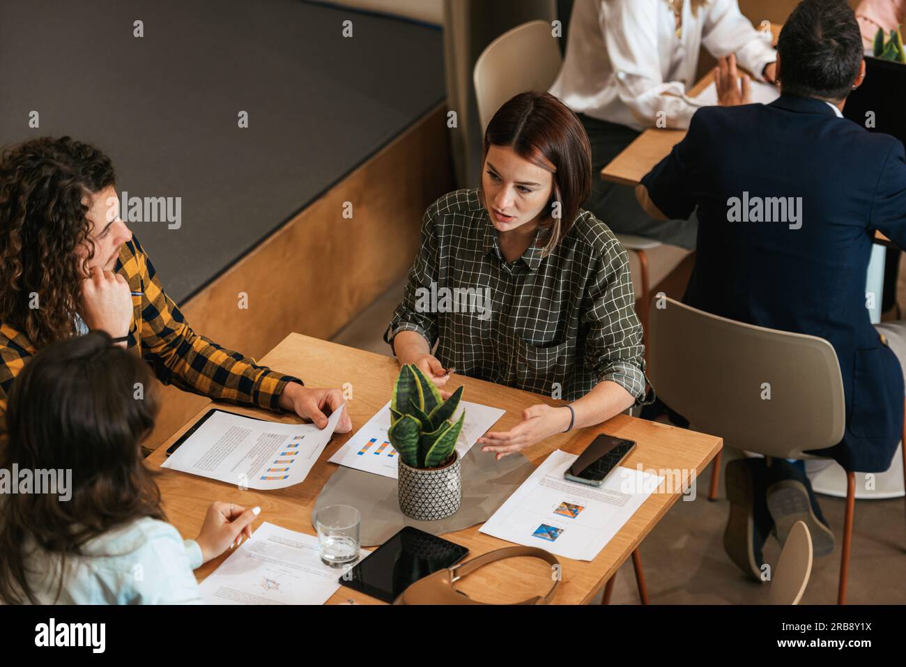 High view of businesspeople working and explaining something to each ...
