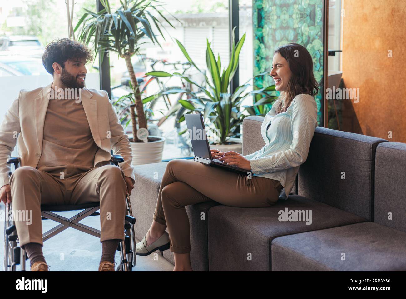 Two colleagues working together in a good atmosphere at the office ...