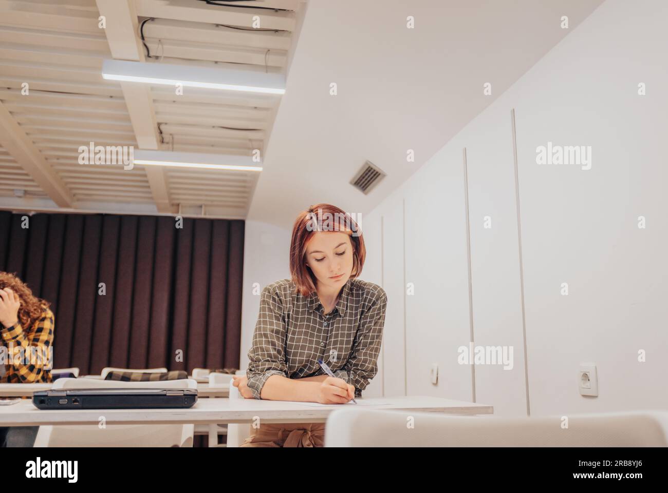 Beautiful student writing answers during exam at school Stock Photo - Alamy