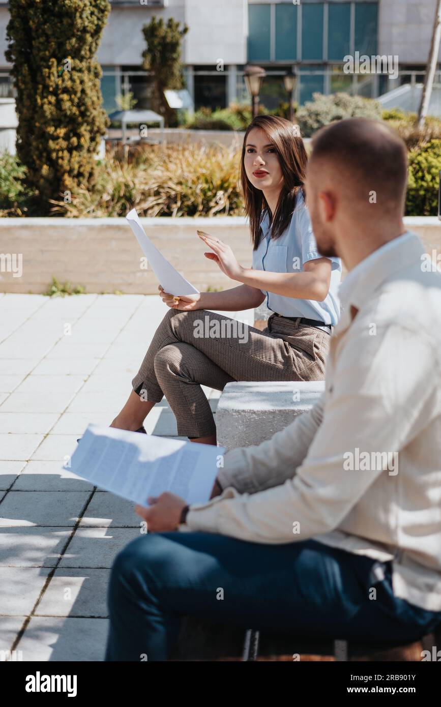 Front view photo of brunette business person talking to her male ...