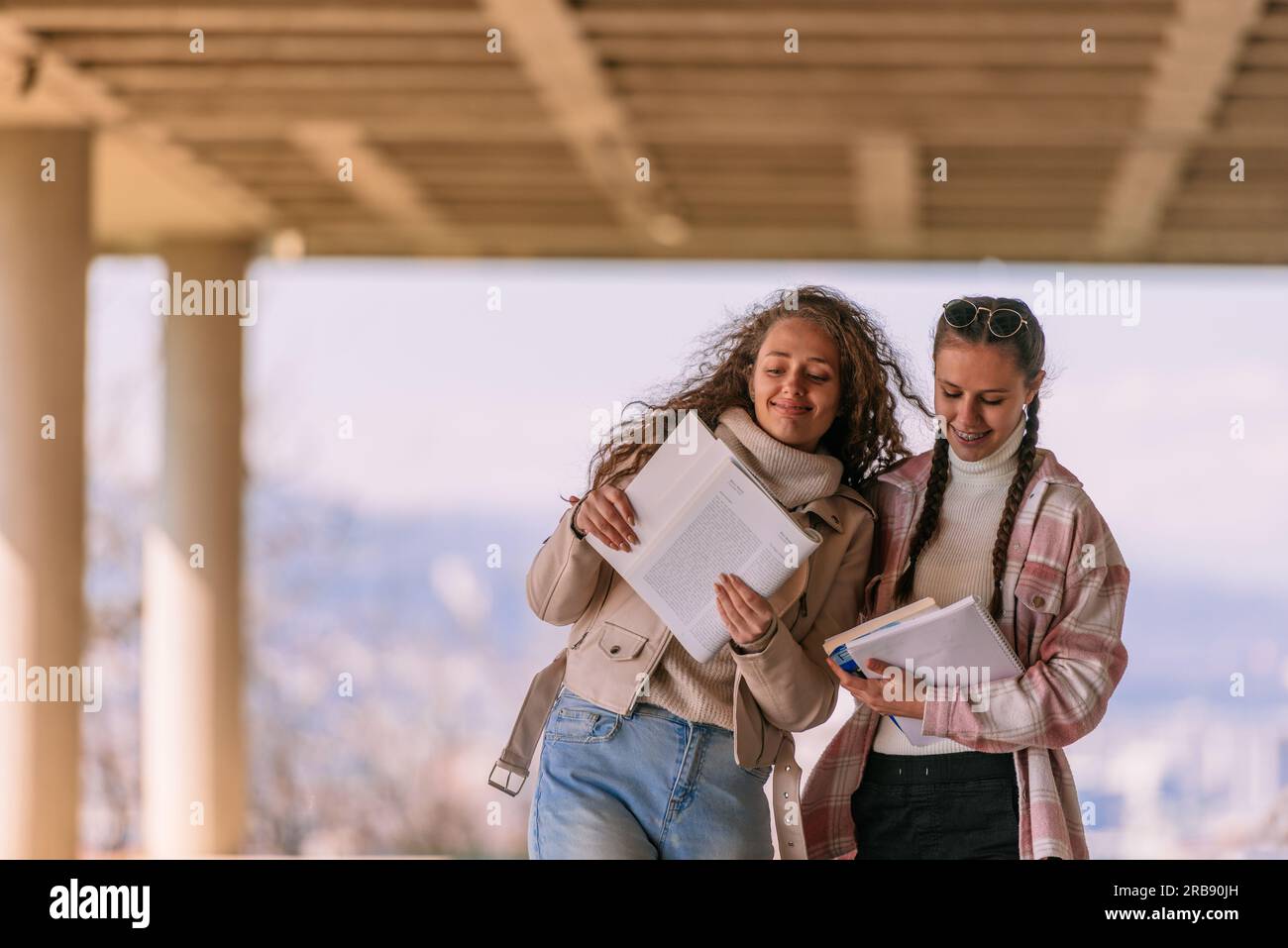 Beautiful high school girls holding books and smiling. Copy space Stock ...