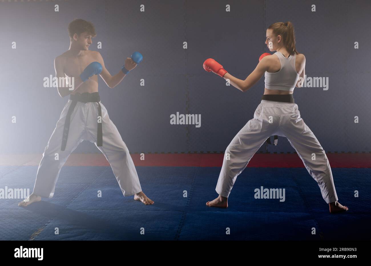 Two young karate friends getting ready to fight at the karate studio ...
