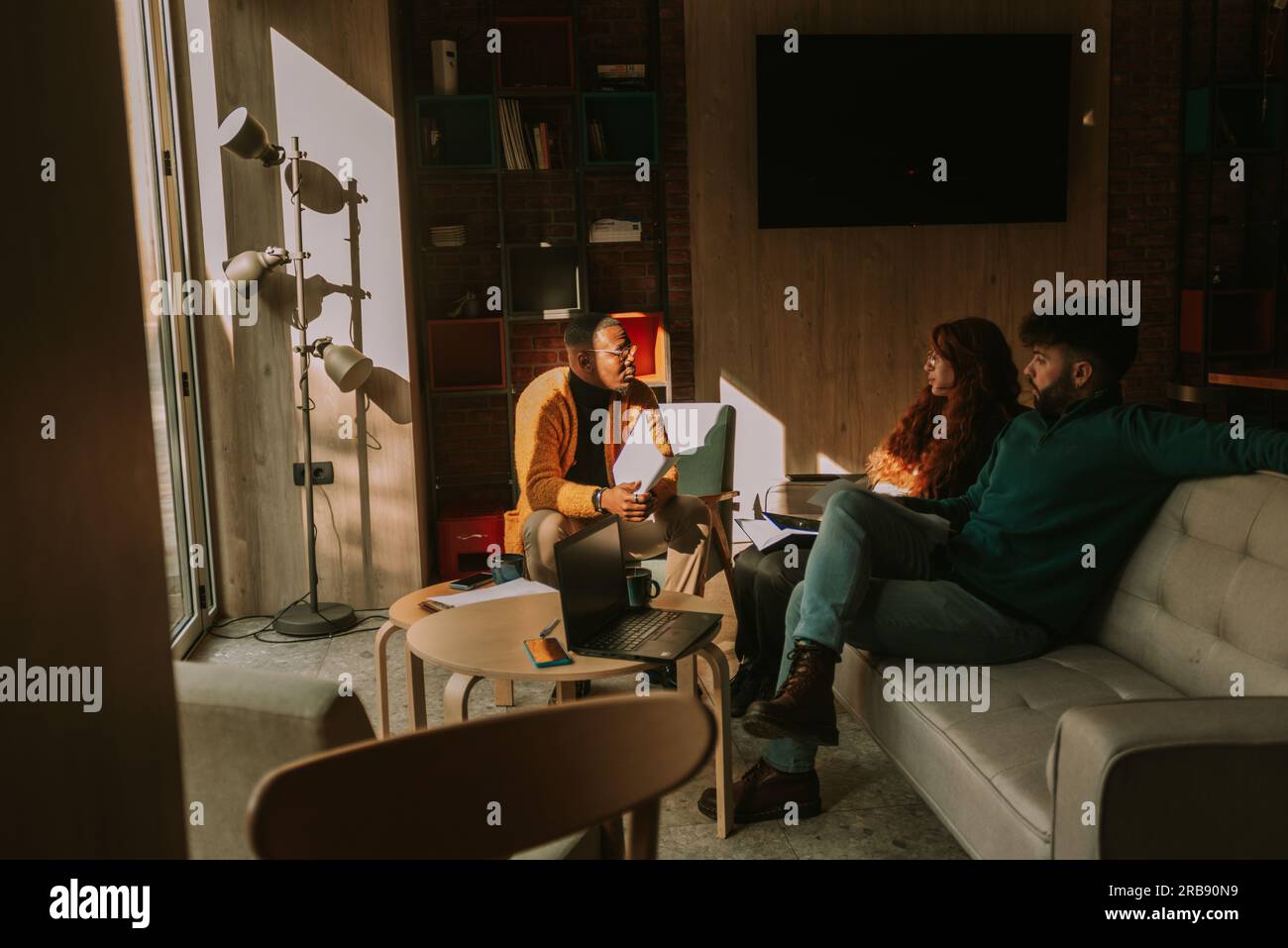 Three people having project discussion hi-res stock photography and ...