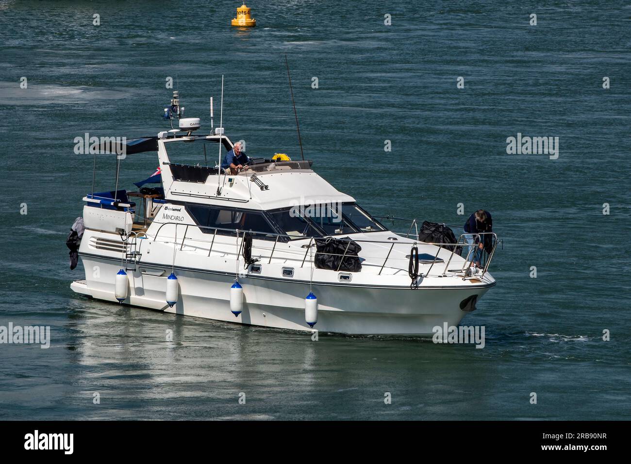 large motor cruiser leaving the harbour at lymington in the new forest ...
