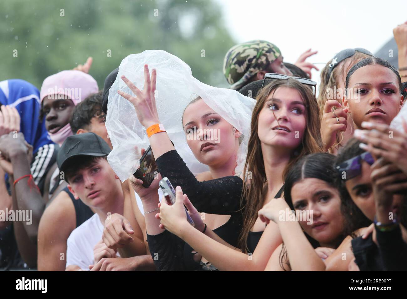 London, UK. July 8, 2023. Crowds try to keep dry at the Wireless ...