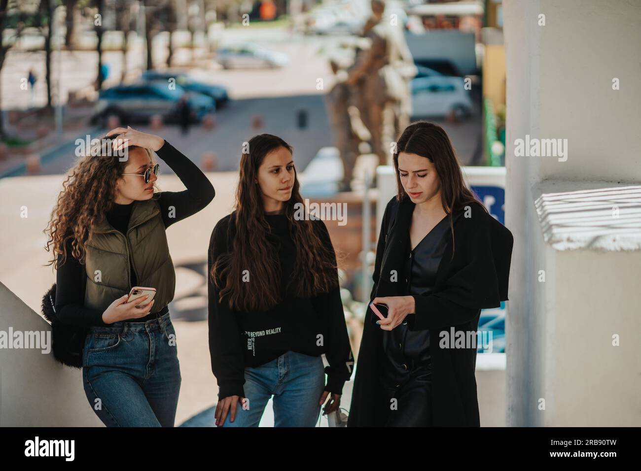 Two girls looking worried at their friend after she started telling a ...