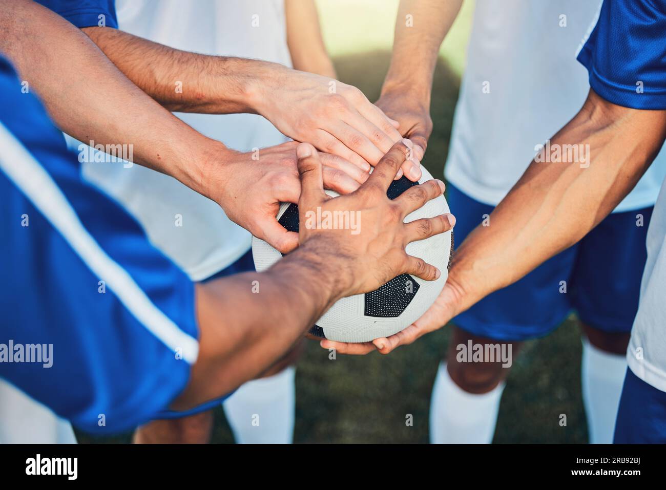 Football, hands together and teamwork, support and sports for training ...