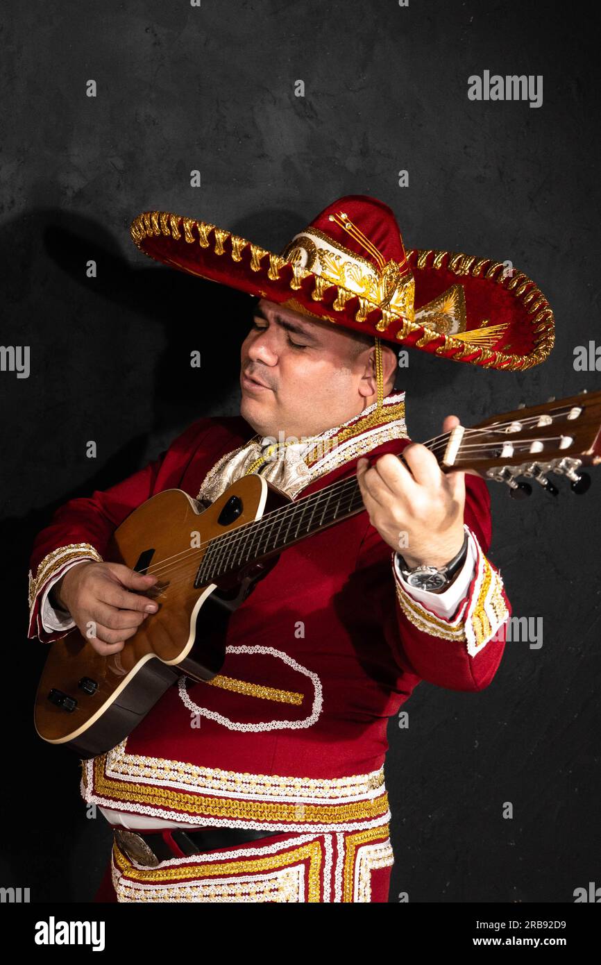 Mexican musician mariachi plays the guitar on a city street Stock Photo ...