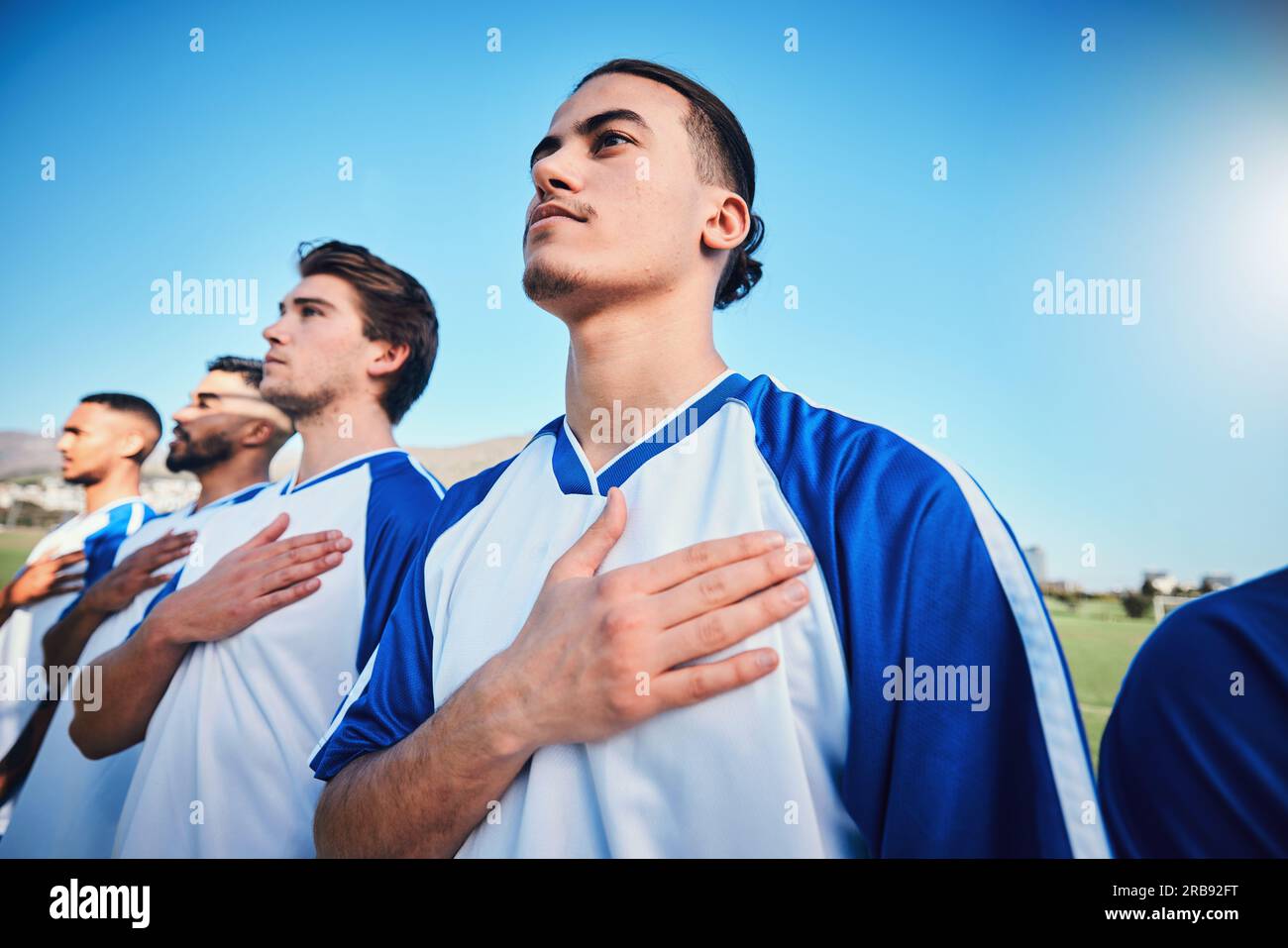 Soccer team, national anthem and listening at stadium with mockup space ...