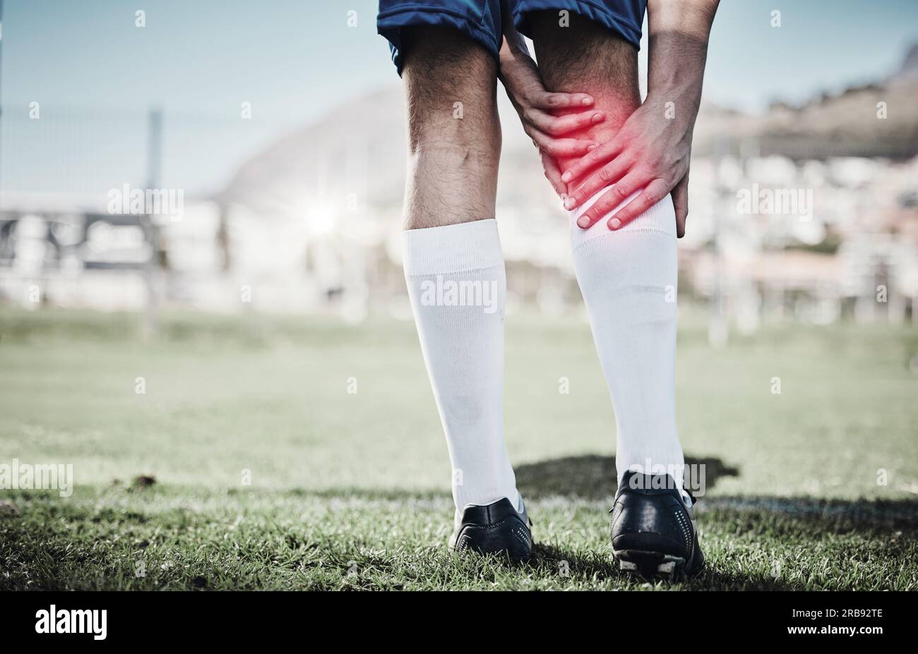 Legs, red pain and hands of sports man or football player on field in ...