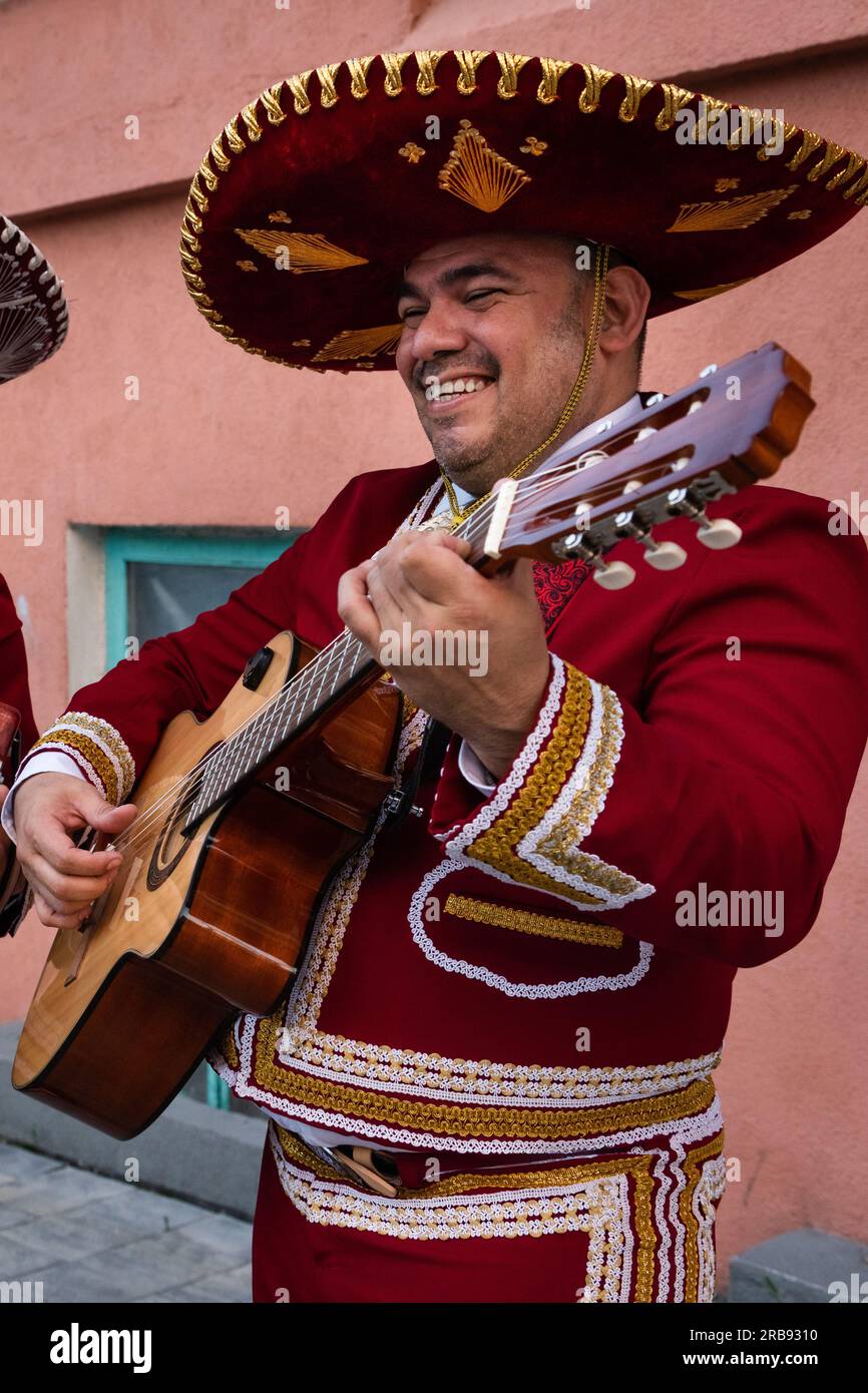 Mexican musician mariachi plays the guitar on a city street Stock Photo ...