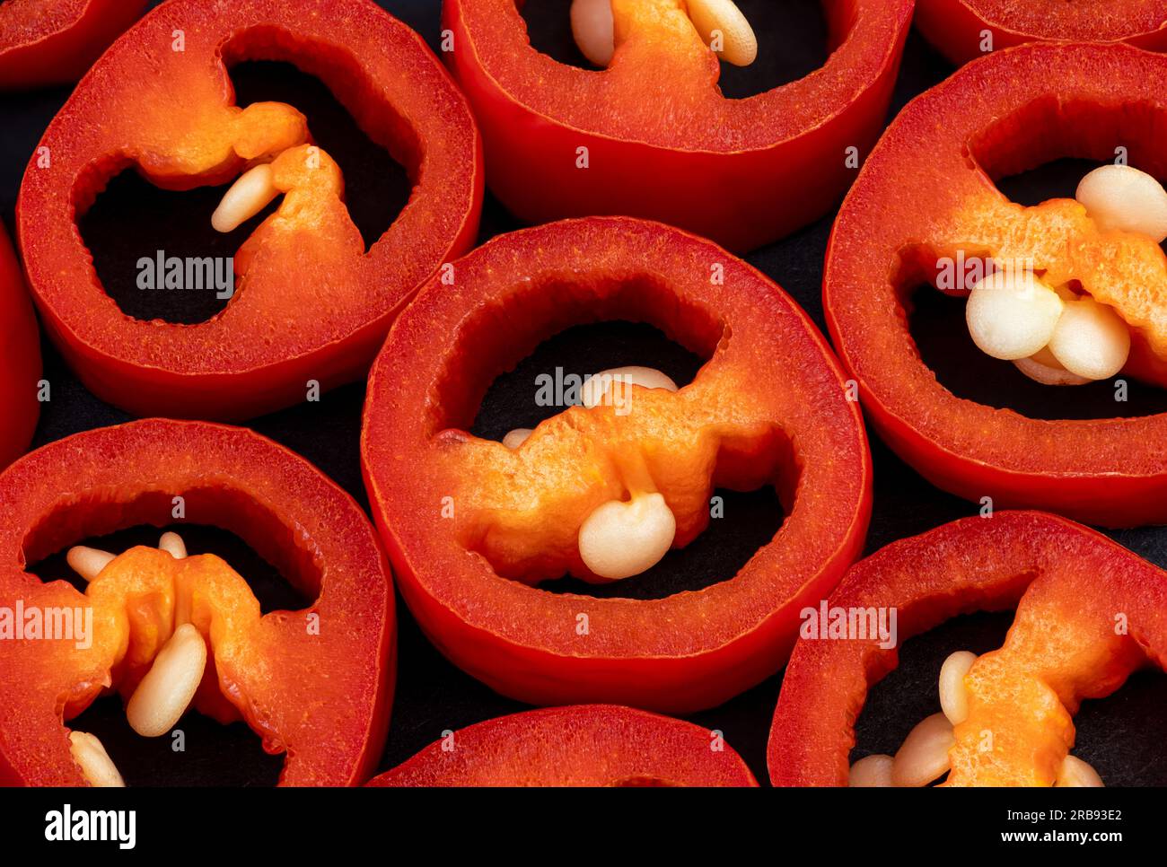 close up of cut red hot chili peppers, Capsicum isolated on black ...
