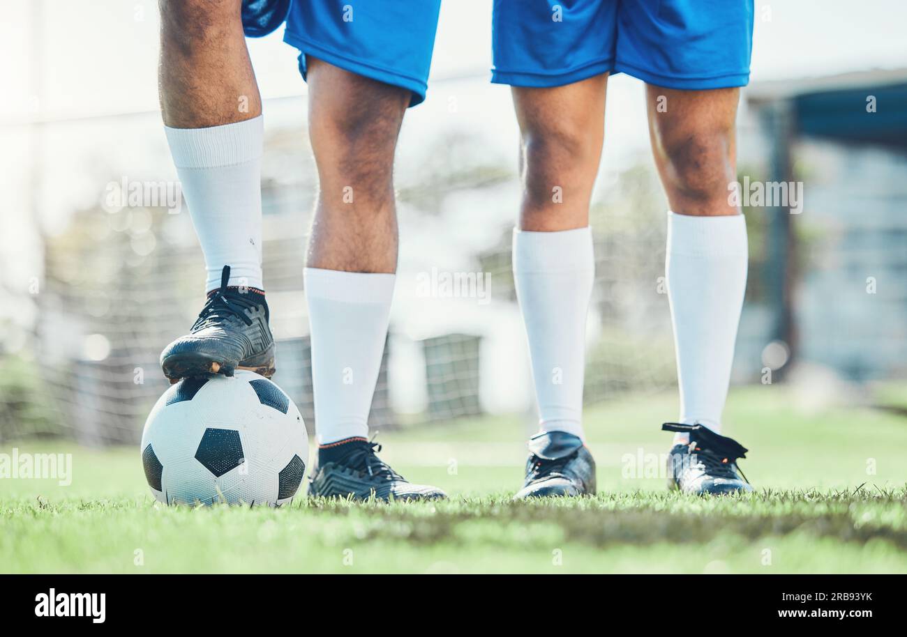 Legs, soccer and ball with a team ready for kickoff on a sports field ...