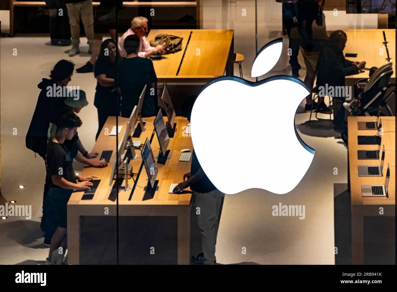 illuminated apple logo and interior of store inside former battersea ...