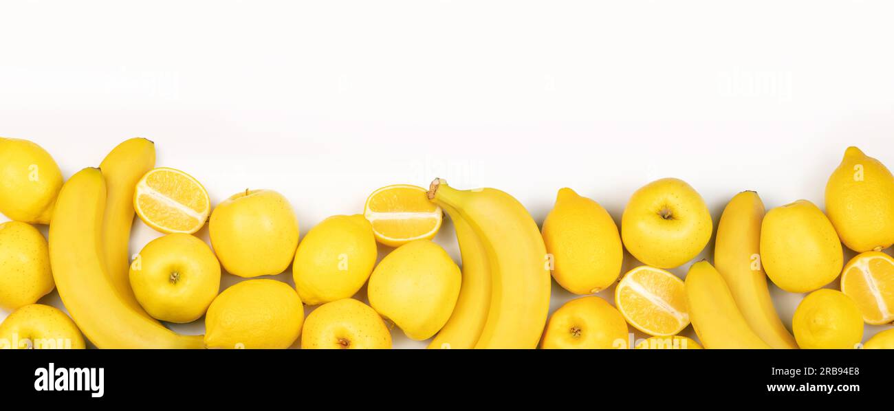 Set of yellow color fruits. Apples, lemons and bananas on a white ...