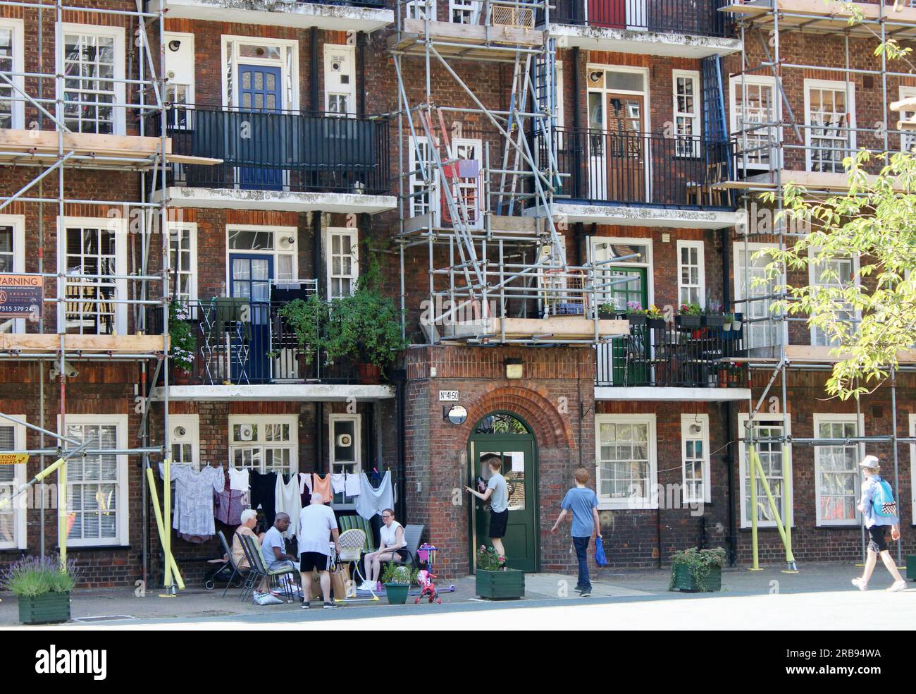 council tenants staying cool outside old style london council housing ...