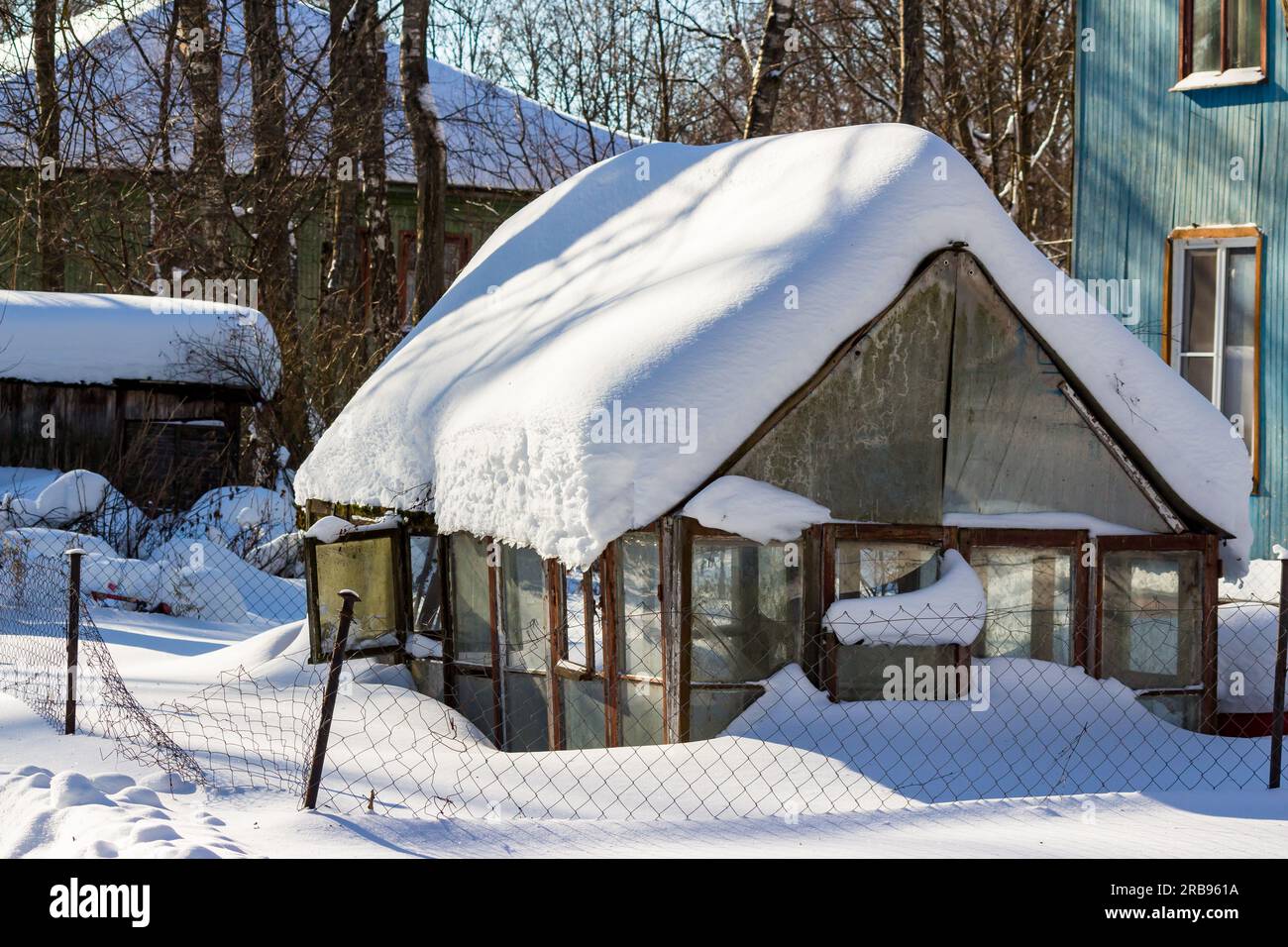 Greenhouse roof covered with snow after a long snowfall, a large layer ...