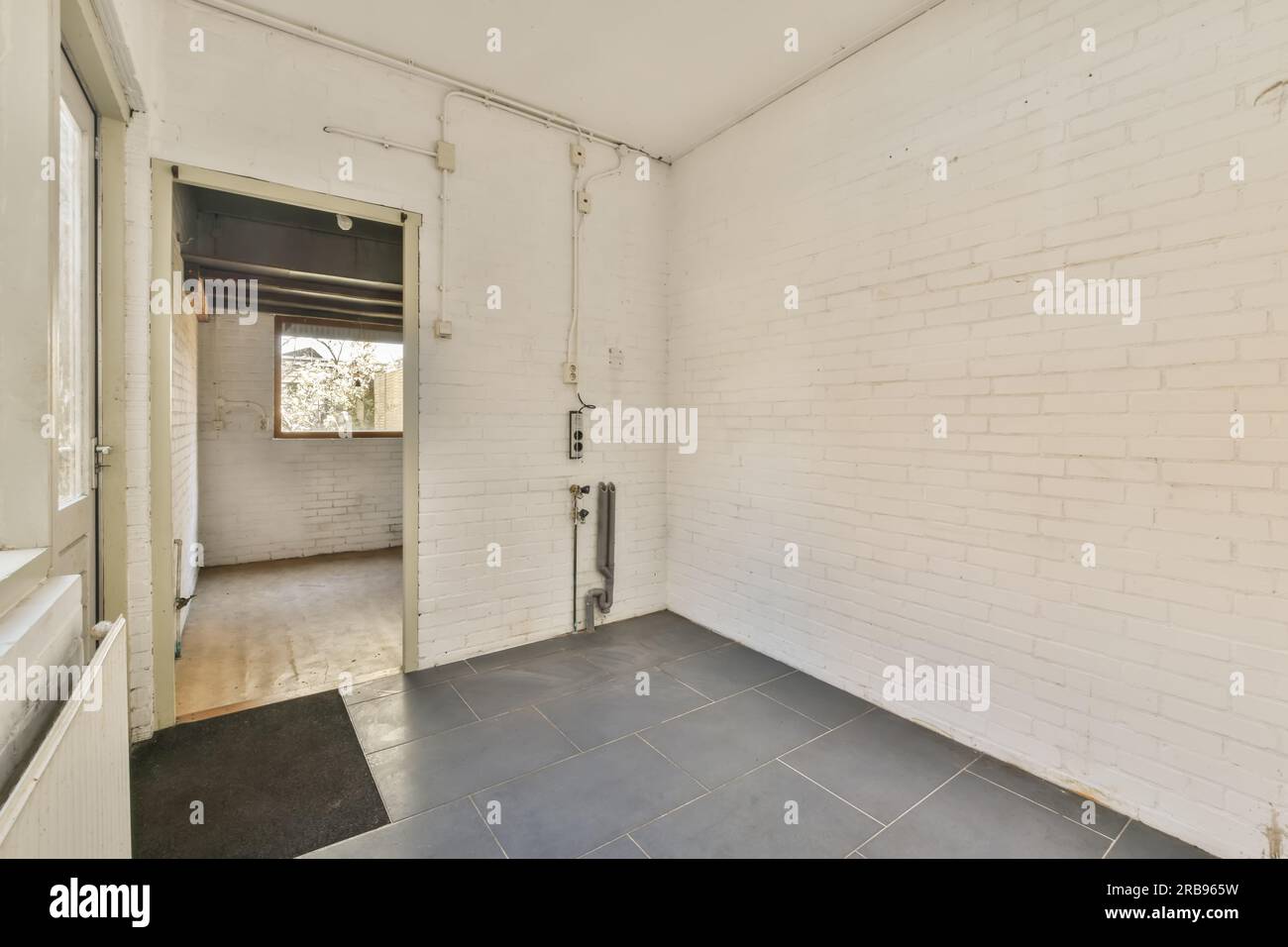 an empty room with white bricks on the walls and floor, there is a ...