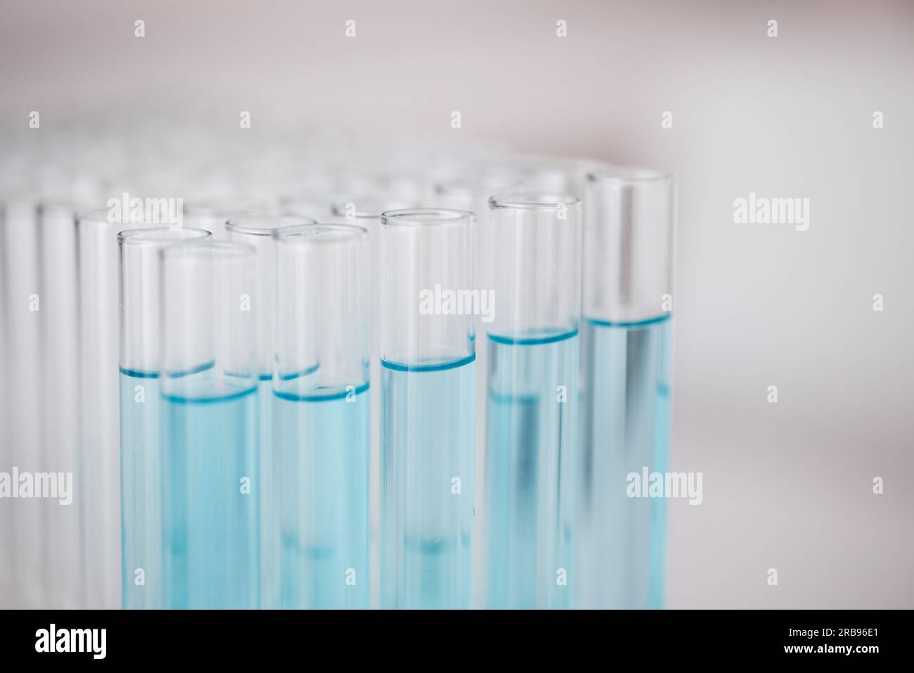 Test tube, blue chemical and closeup, chemistry and science study in ...