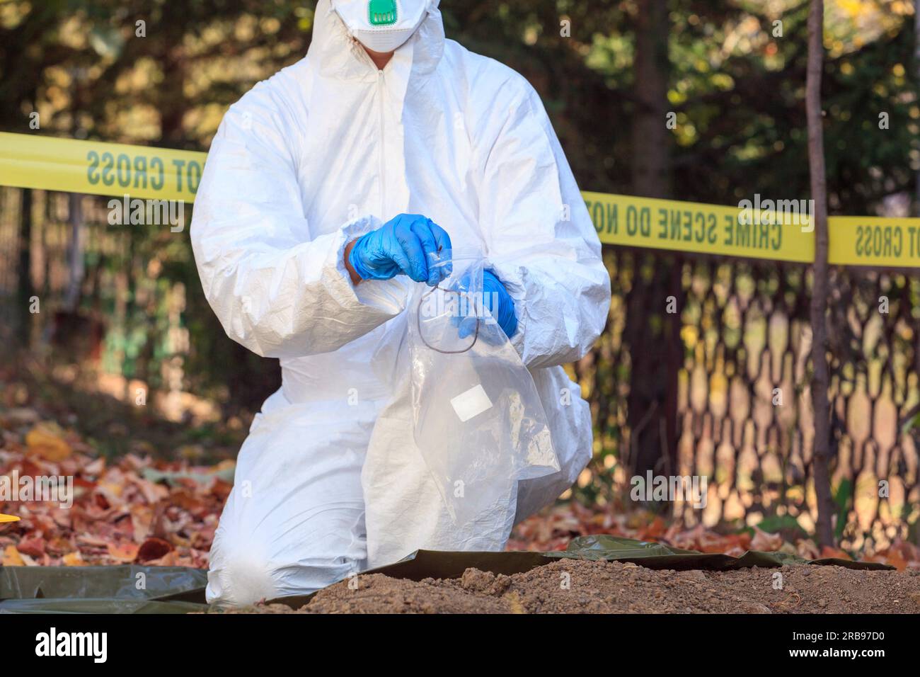 Forensic science specialist at work at a war massacre investigation ...