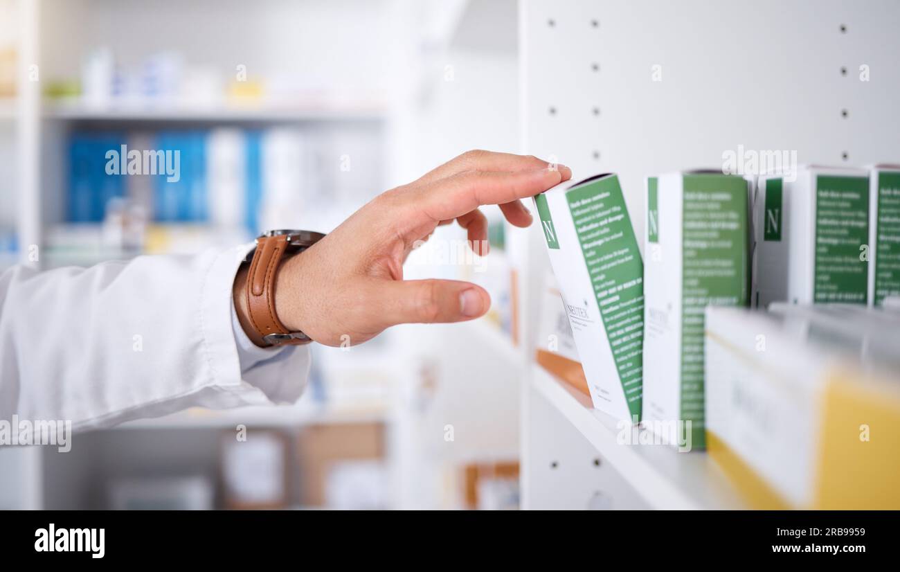 Pharmacist hand, shelf and boxes with choice, packing stock and ...