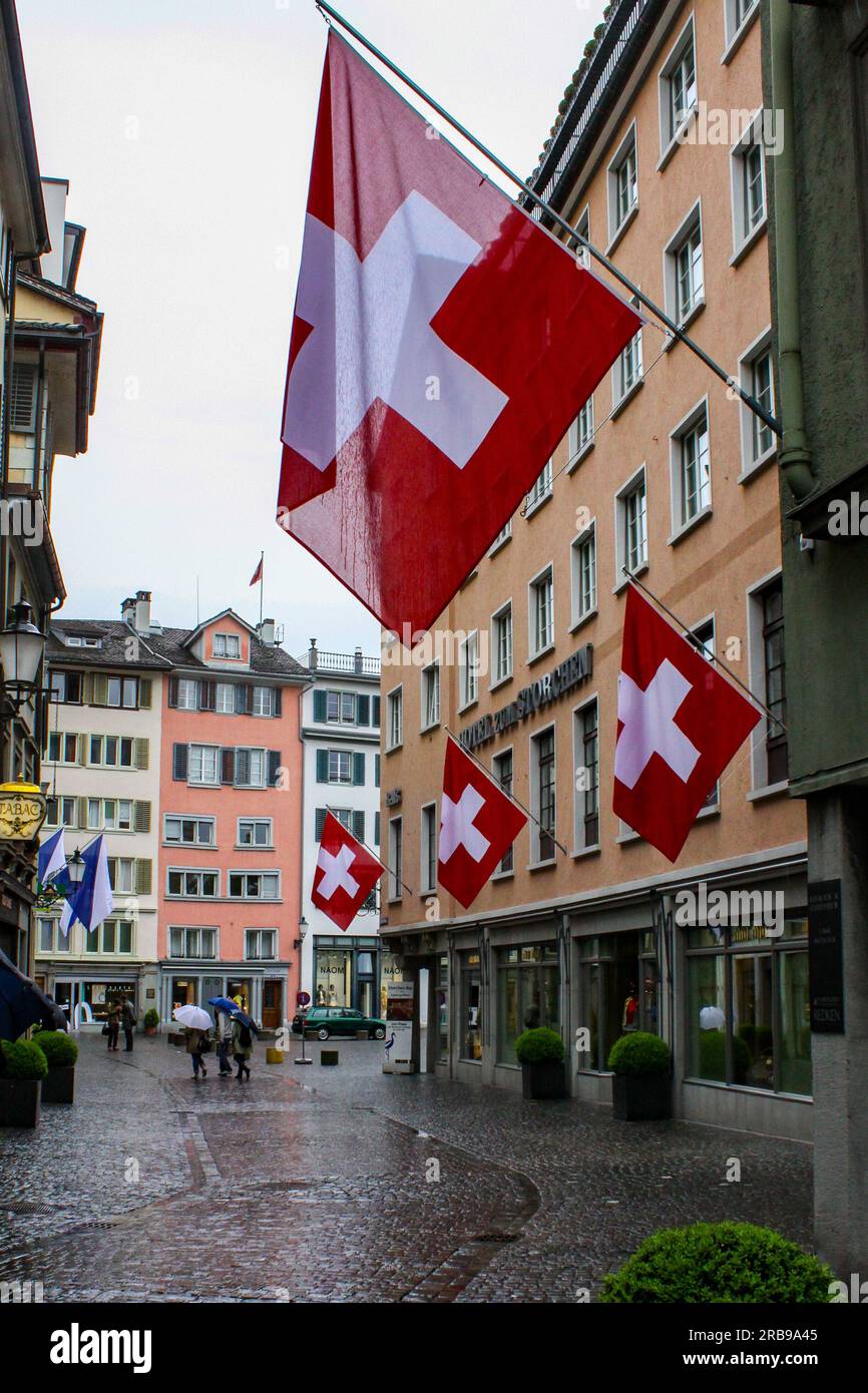 Zurich city centre with Swiss flags on a rainy day Stock Photo - Alamy