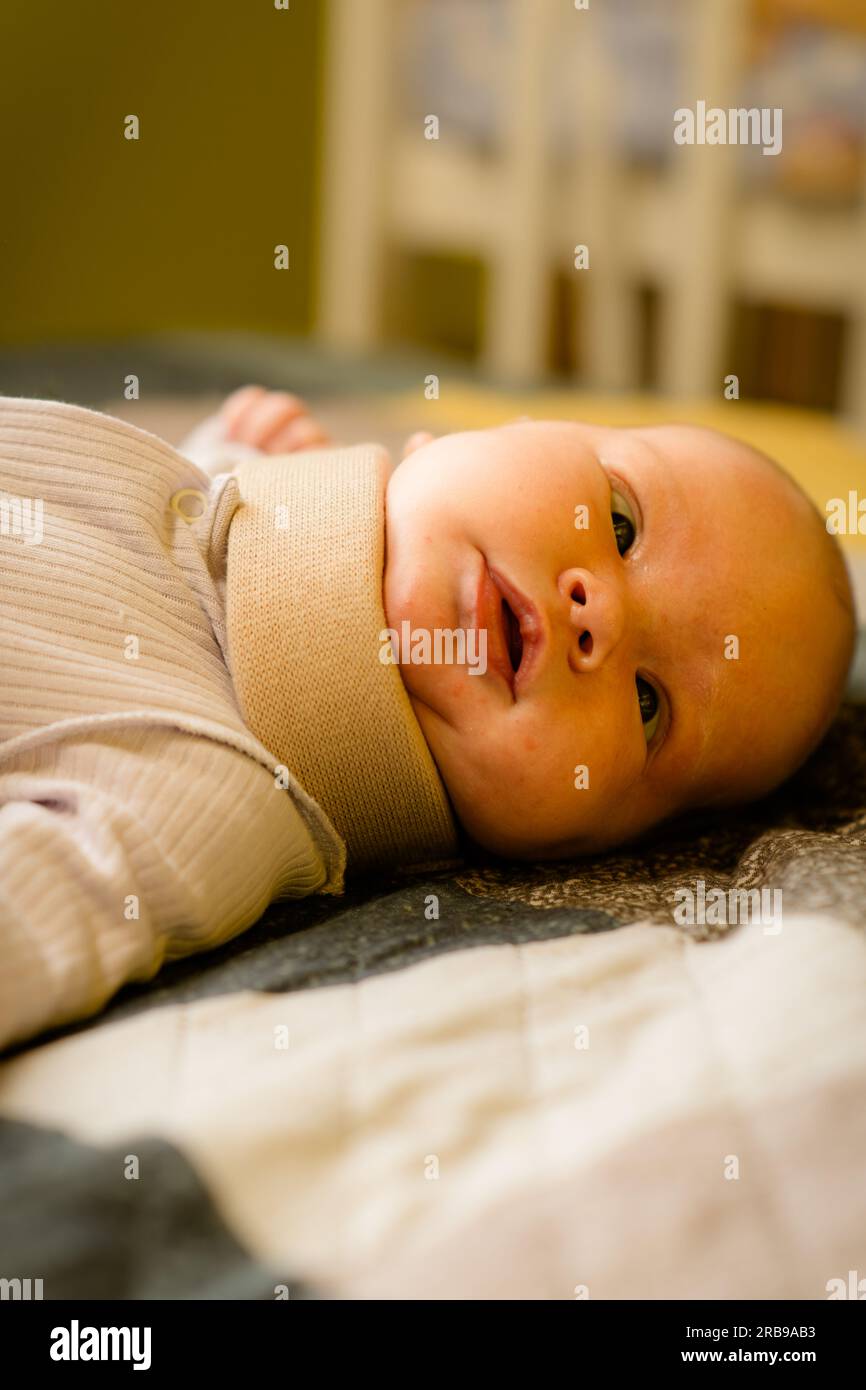 Cute newborn baby in a neck brace. Kid wearing cervical collar ...