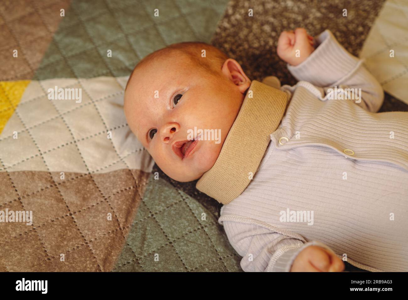 Cute newborn baby in a neck brace. Kid wearing cervical collar ...