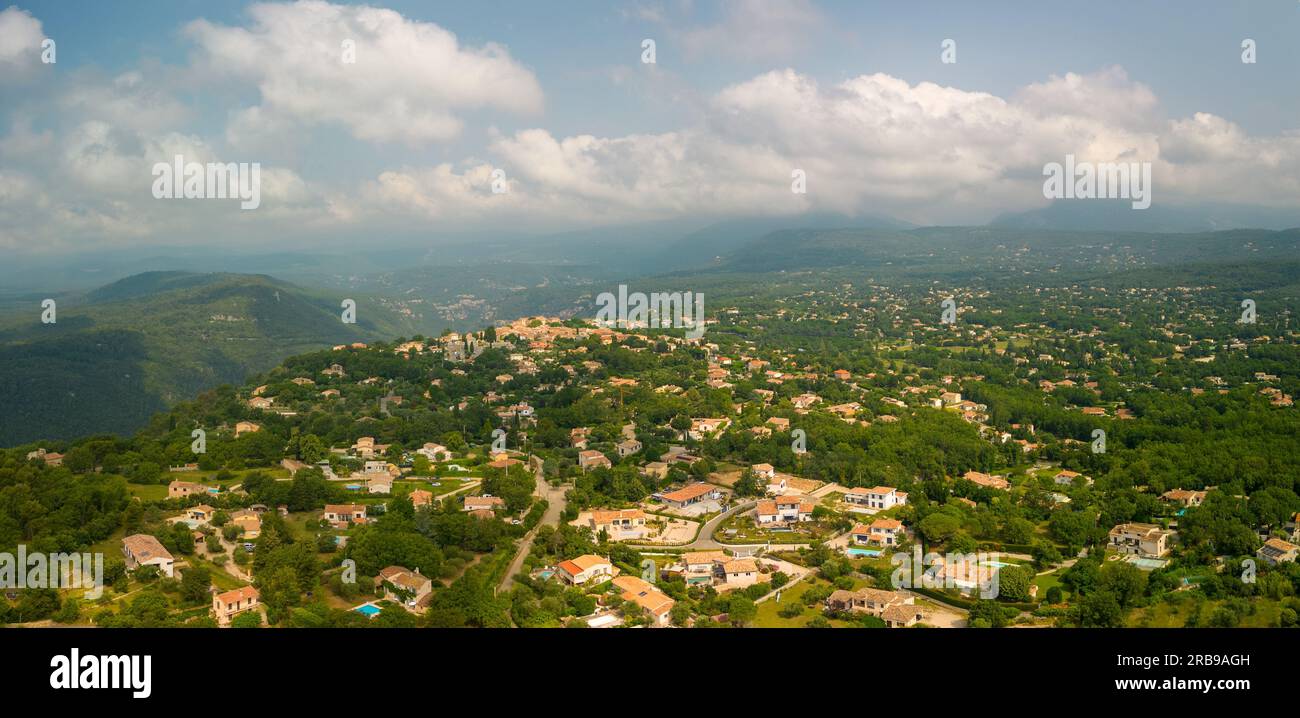 French villas dot beautiful green landscape outside village on sunny ...