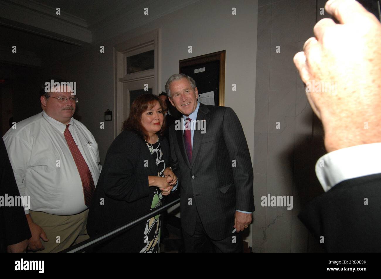 Department staff greeting President George W. Bush, from behind rope ...