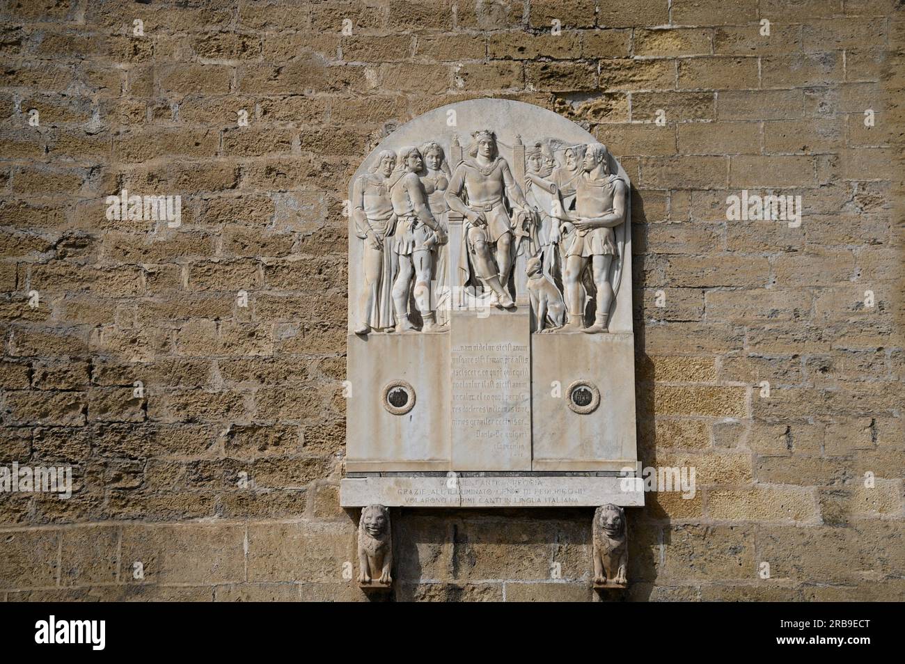 Marble memorial sculpture on the exterior wall of the Norman-Gothic ...