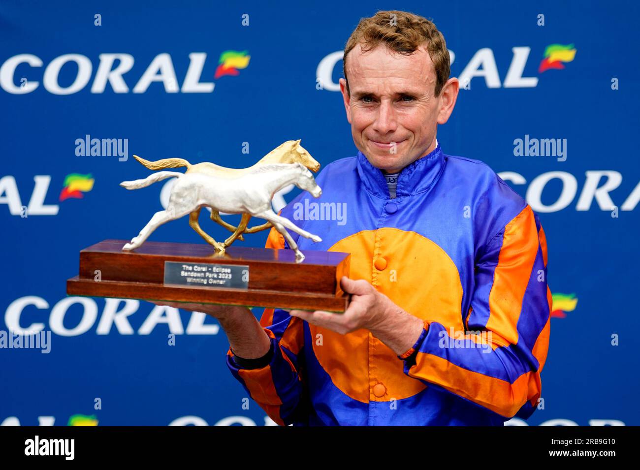 Jockey Ryan Moore poses for a photo with the trophy after winning the ...